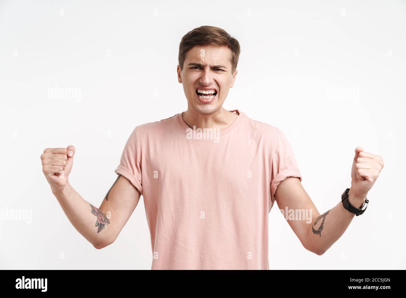 Image of cheerful caucasian man in basic t-shirt smiling and rejoicing ...