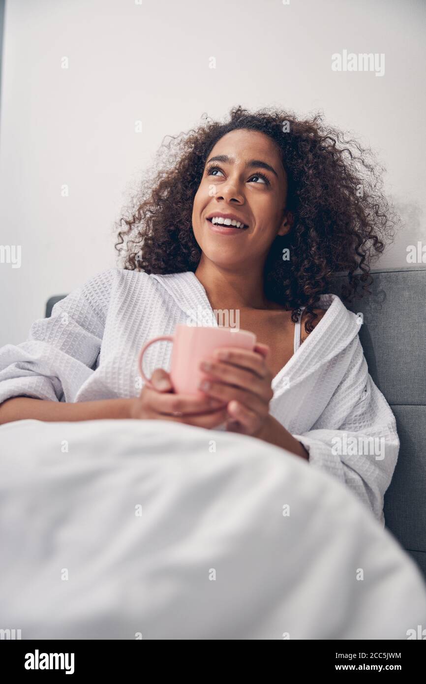 Smiling young female staring at the ceiling Stock Photo - Alamy