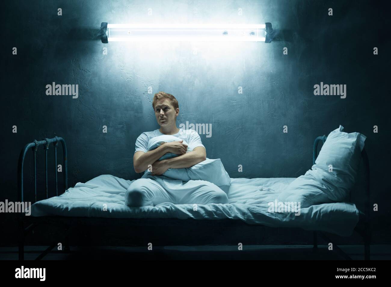 Sad man sitting in dark hi-res stock photography and images - Alamy