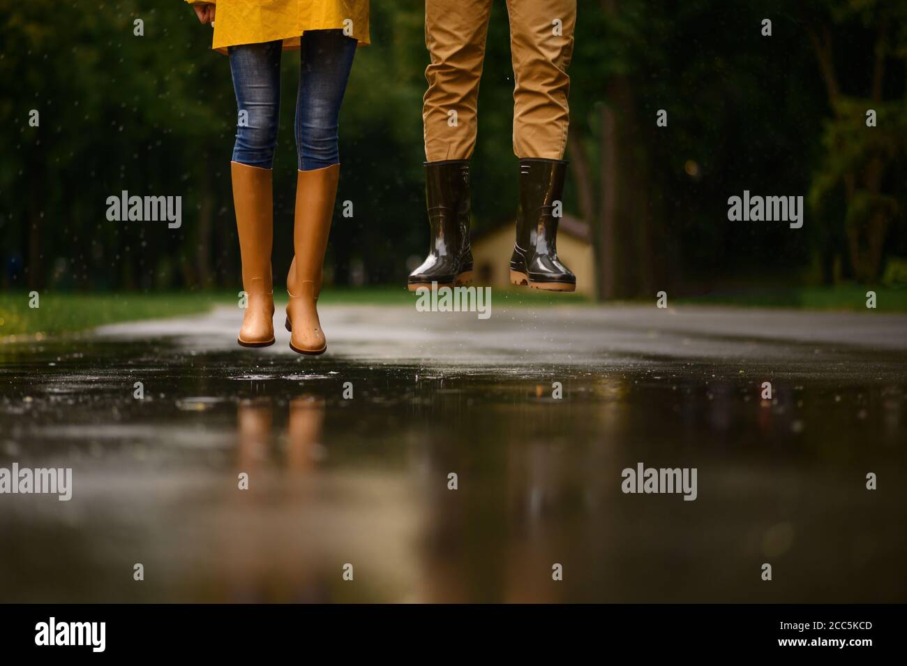 Love couple jumps in a puddle in park, rainy day Stock Photo - Alamy