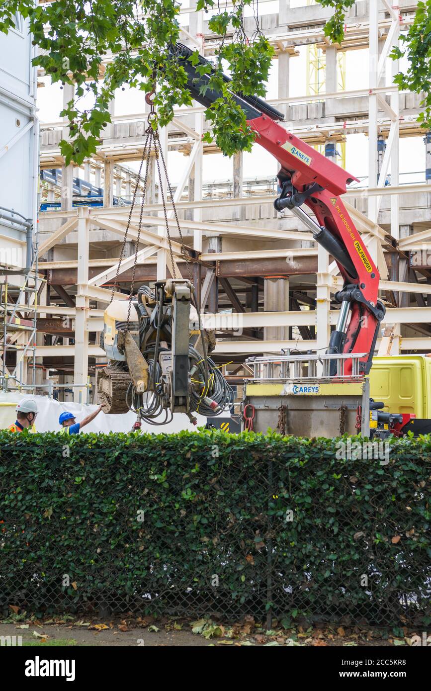 Small excavator machine being offloaded from a lorry during ...