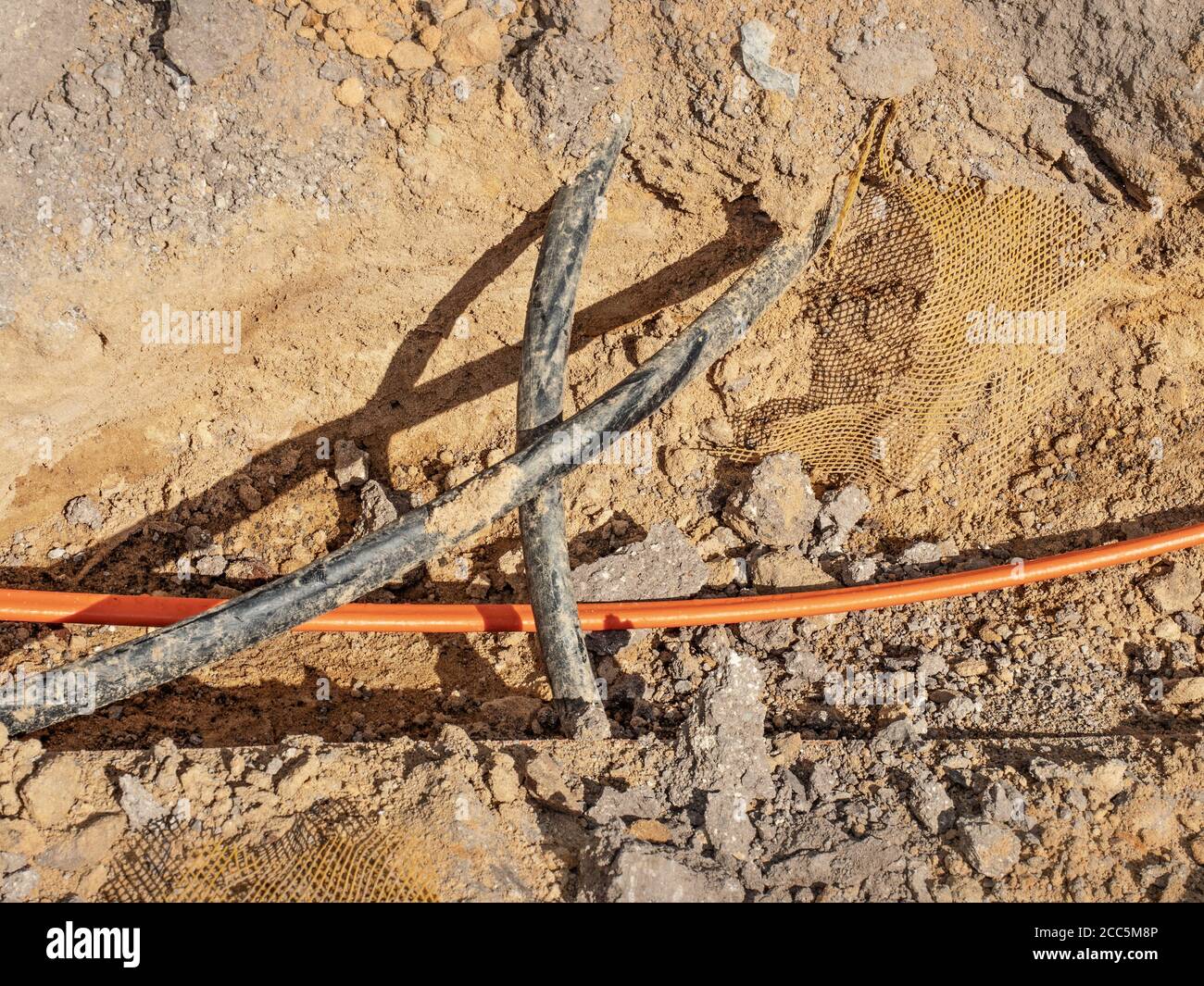 Safety tube with optic fiber cables. Bulding site with trench for ...