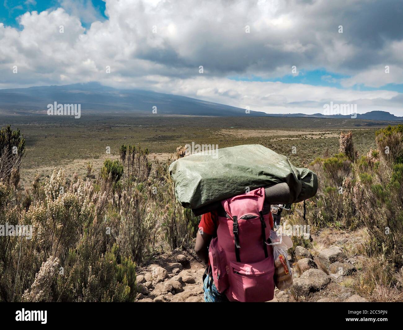 guides porters and sherpas carry heavy sacks as they ascend mount ...