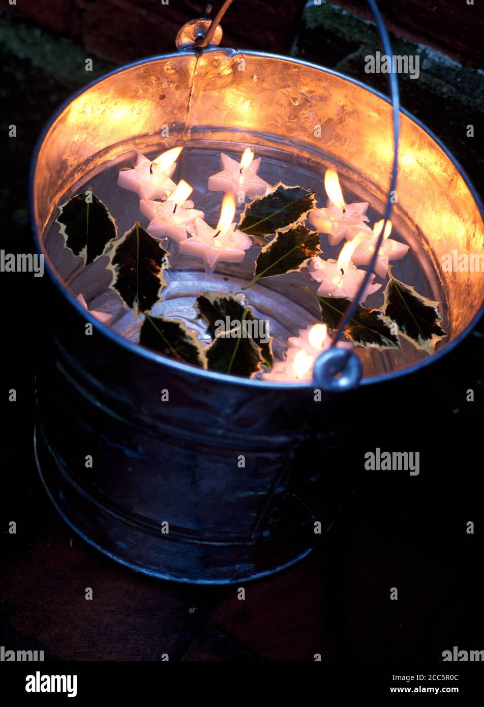 Floating star candles in aluminium bucket Stock Photo - Alamy
