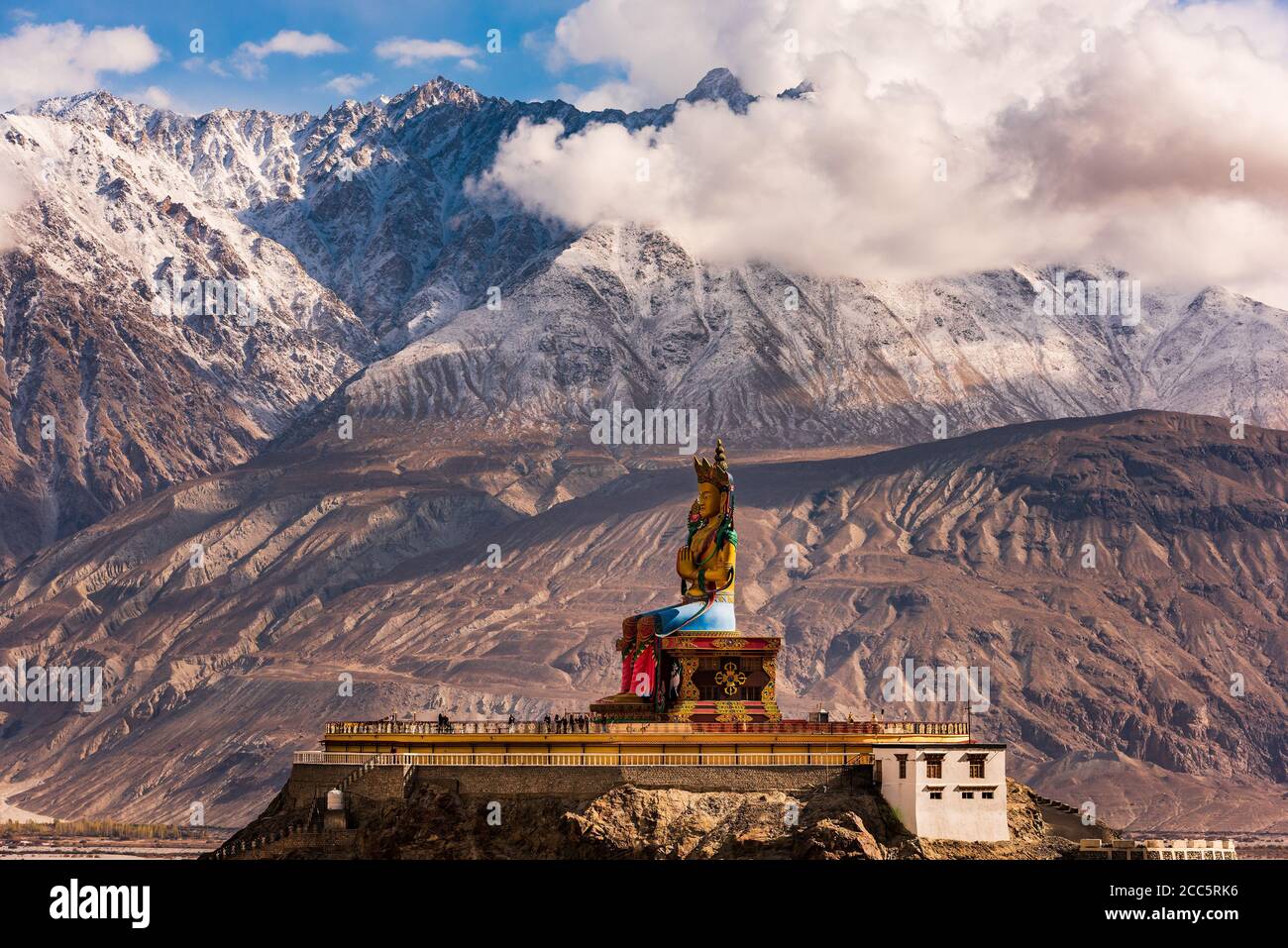 The Maitreya Buddha statue with Himalaya mountains in the background ...