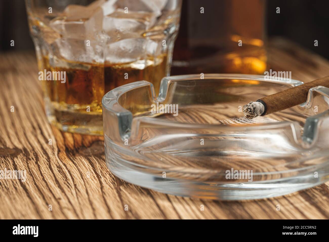 Lighted cigar in an ashtray close up Stock Photo - Alamy
