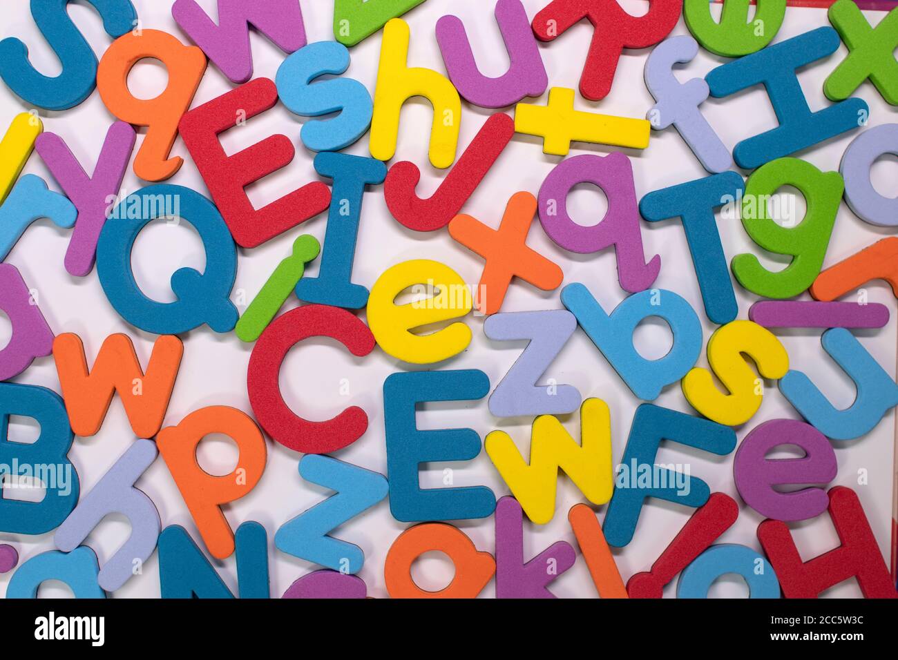 Colorful sponge magnetic letters on white background Stock Photo - Alamy