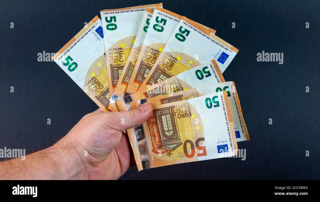 man with 50 euro bills holding them in a fan shape Stock Photo - Alamy