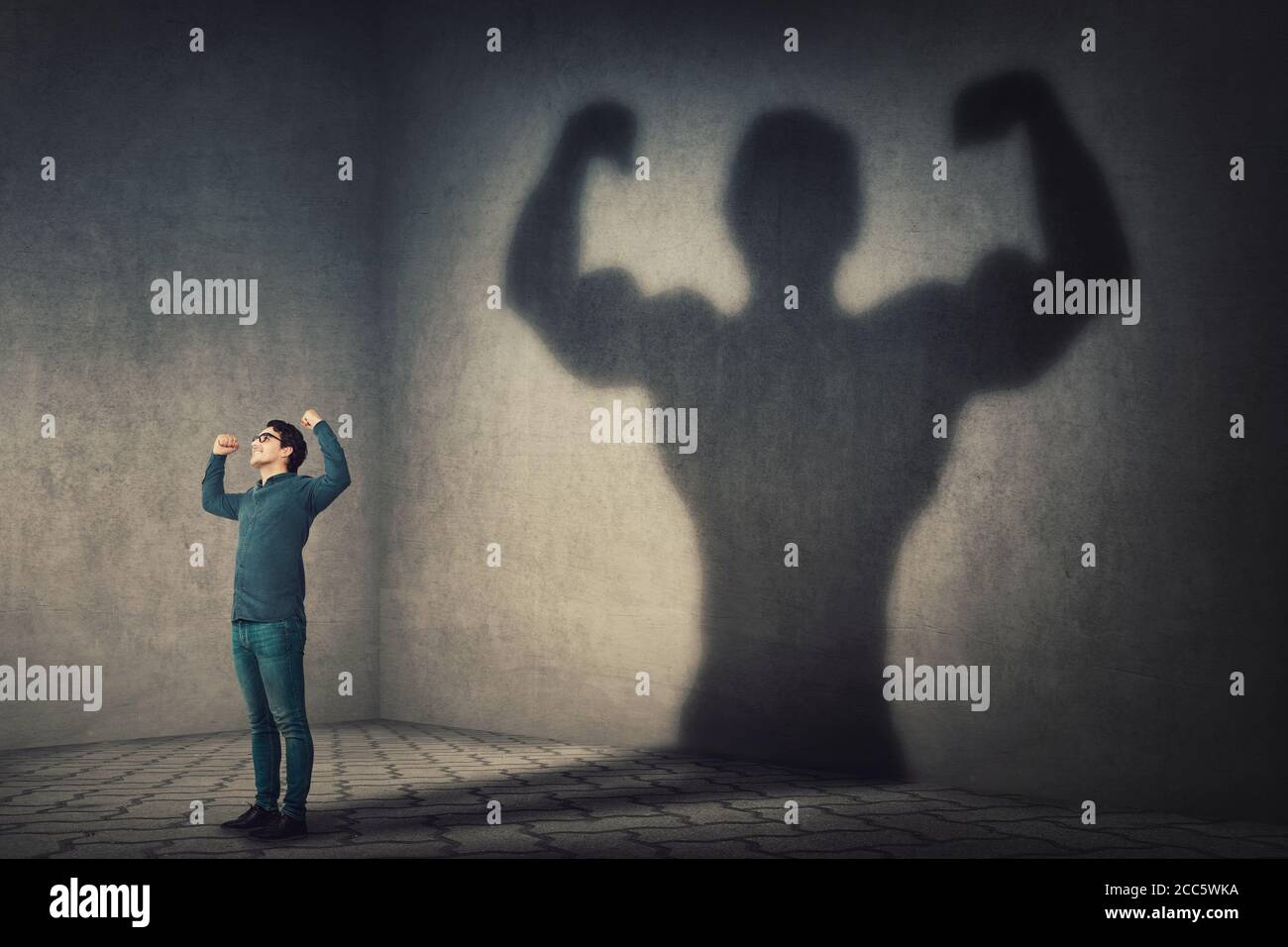 Confident man flexing muscles imagine super power as casting a shadow ...