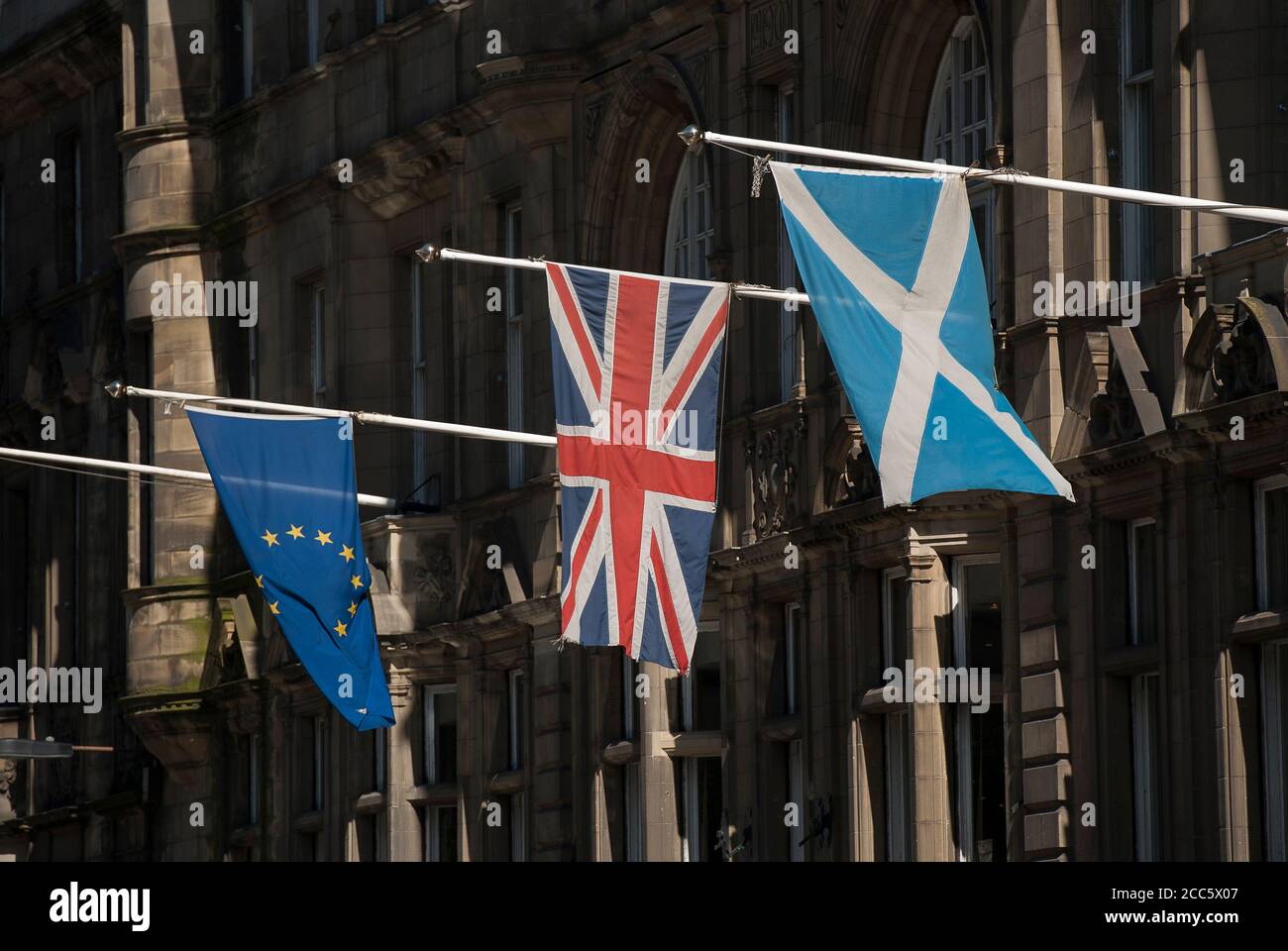 Flags flying outside a building on Lawnmarket in the city of Edinburgh ...