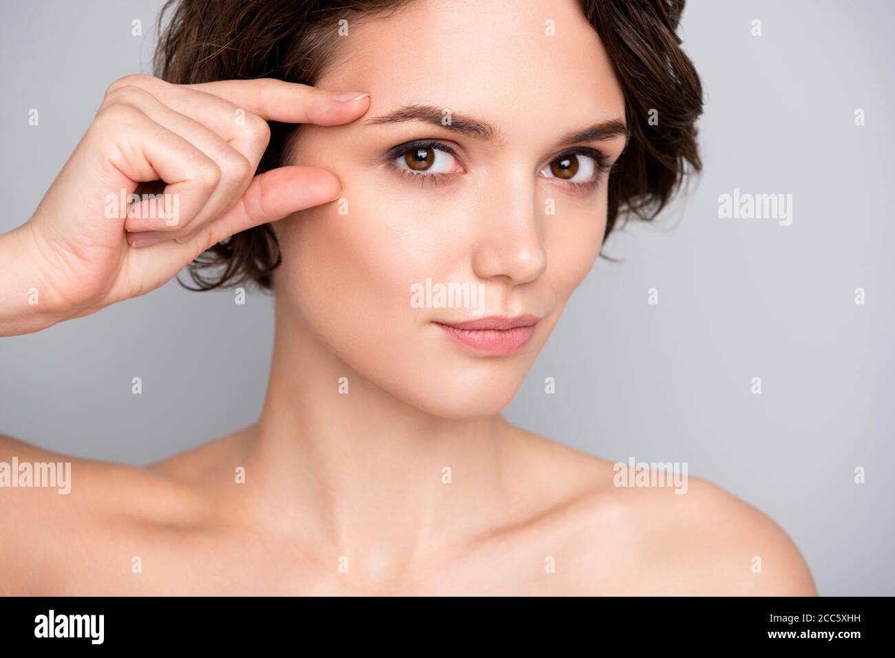 Close up photo of charming pretty gorgeous girl touch finger eyes look ...