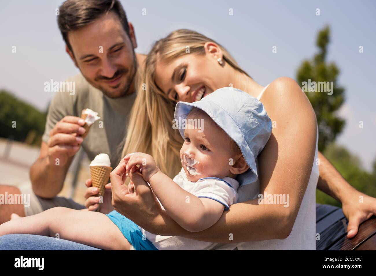 Parents having fun with their kid on a beautiful sunny day Stock Photo ...