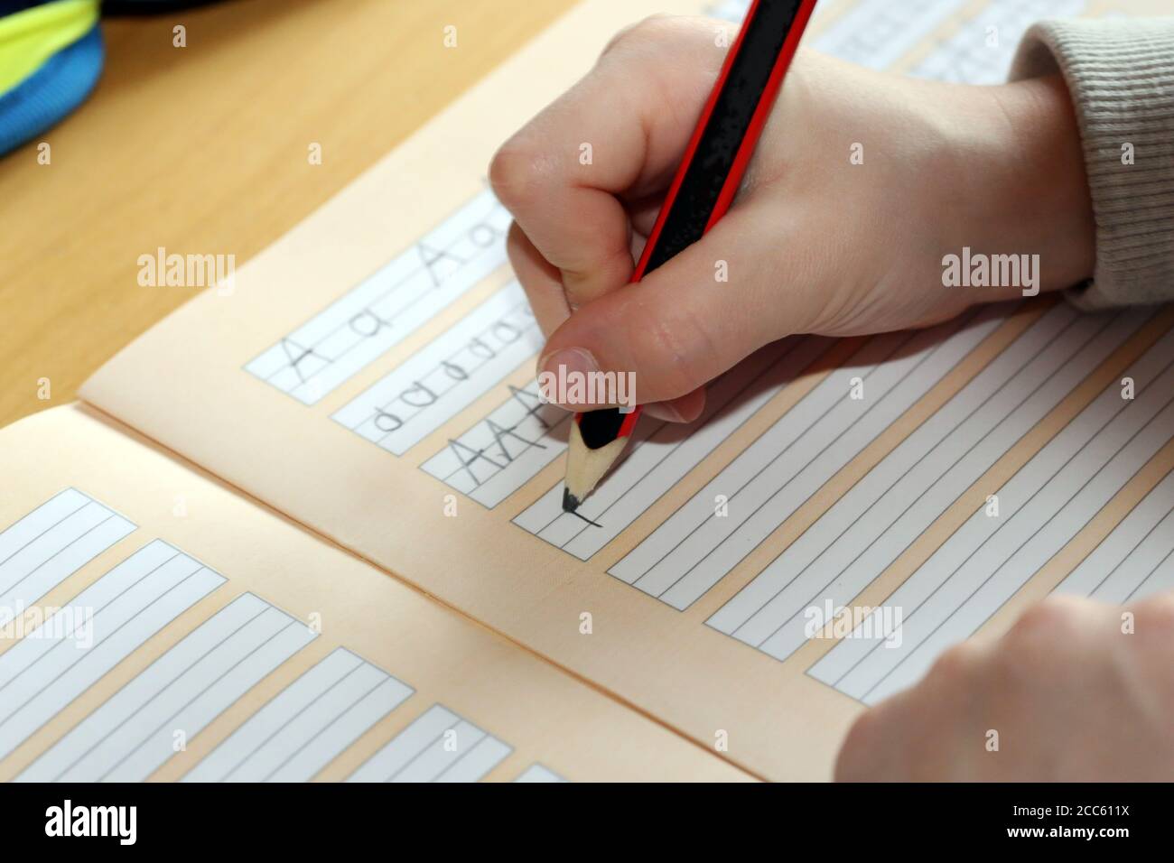 Child writing with pencil hi-res stock photography and images - Alamy