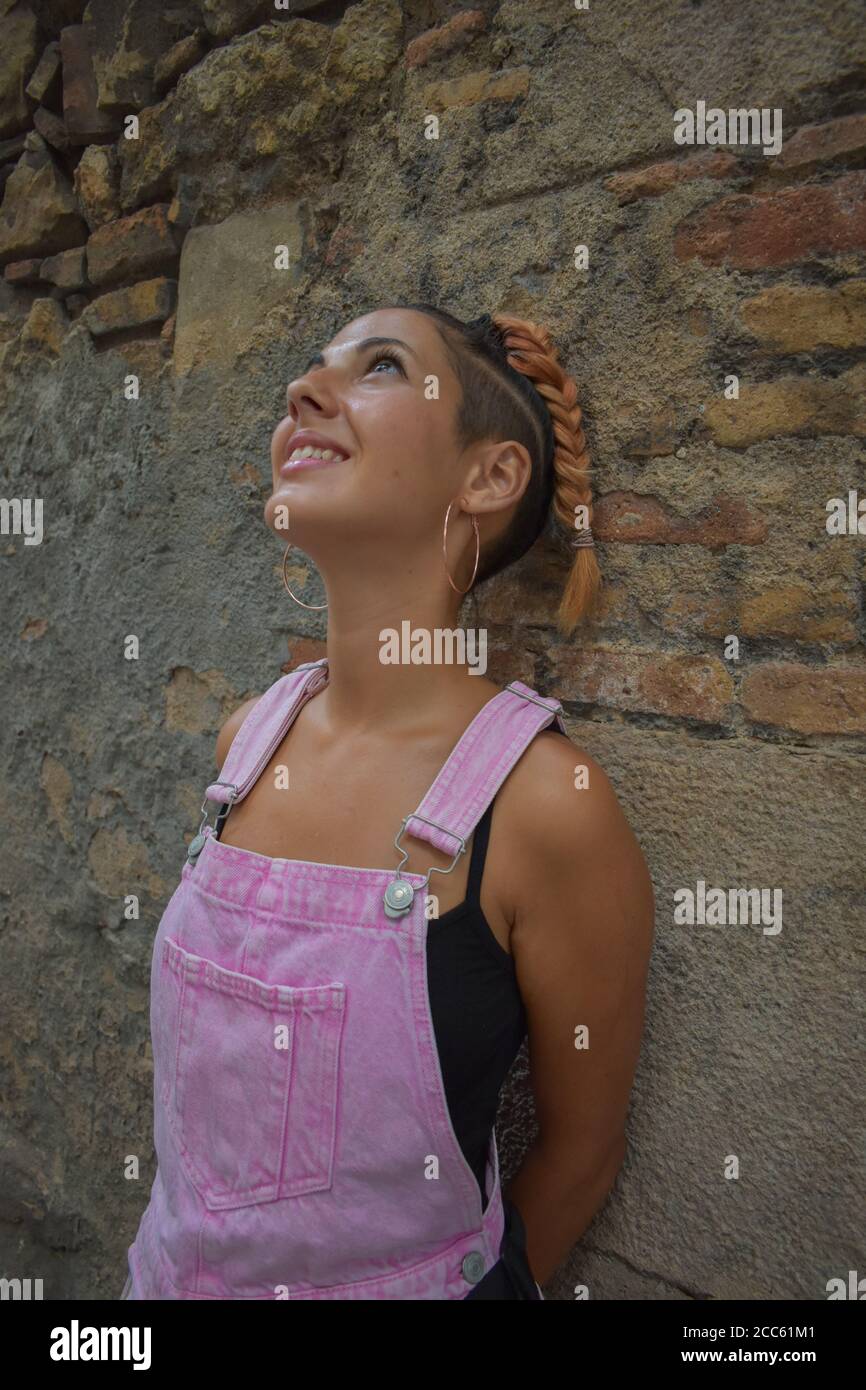 Vertical shot of attractive female posing against a wall Stock Photo ...
