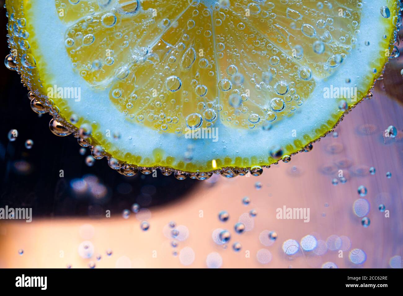 Lemon slice floating in drink Stock Photo - Alamy