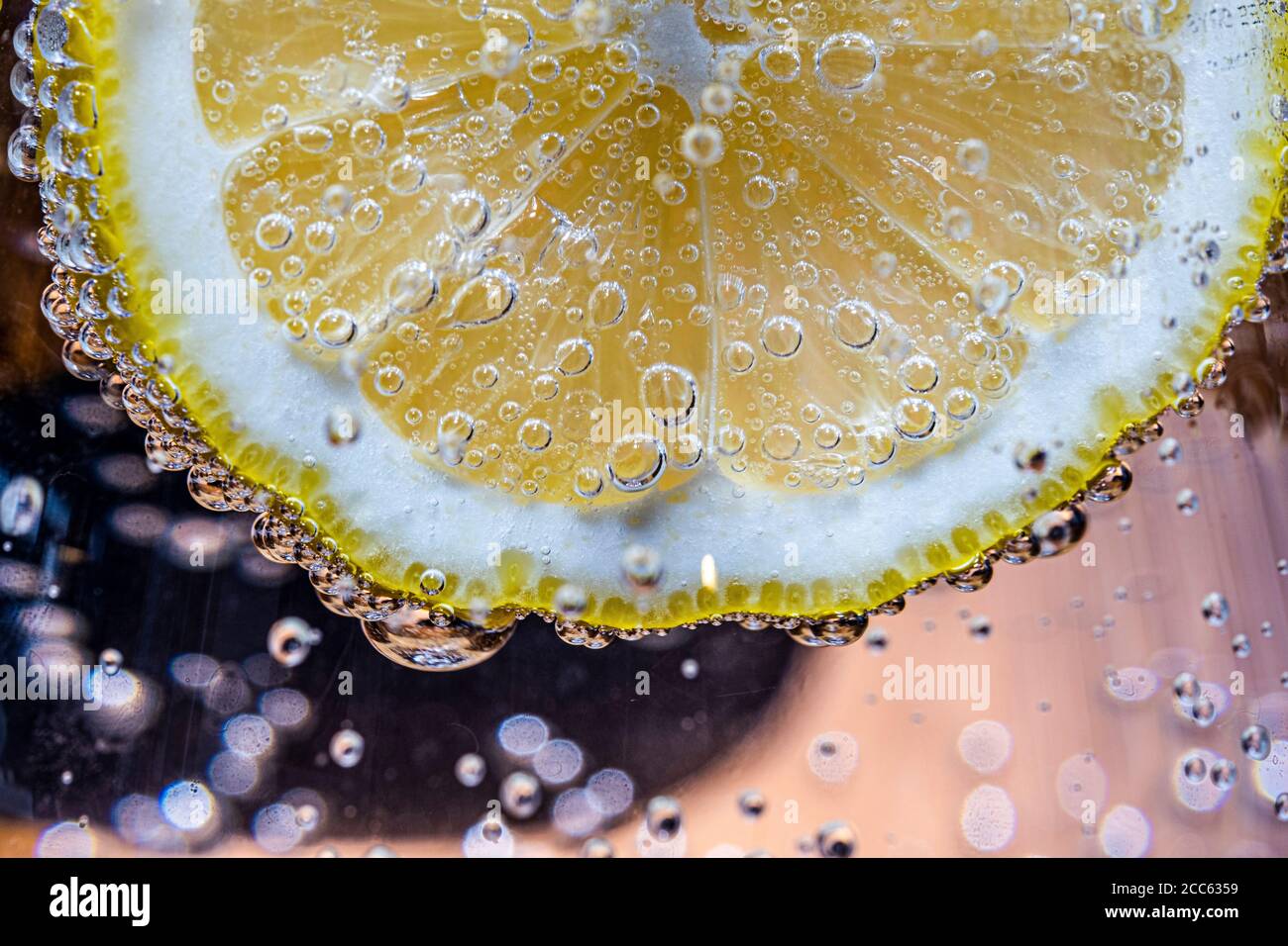 Floating lemon slice under water Stock Photo - Alamy