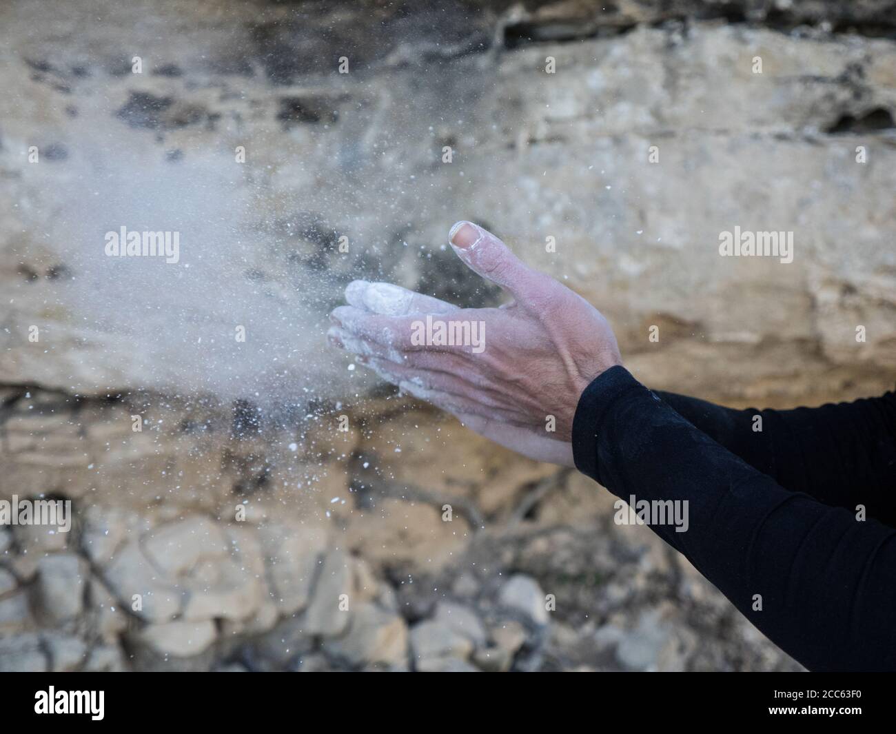 Climbing male covering his hands with magnesium powder chalk Stock ...