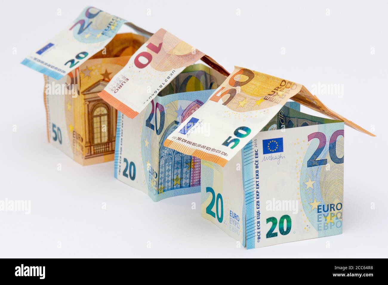 Houses made of 10, 20 and 50 euro bank notes, white background Stock ...