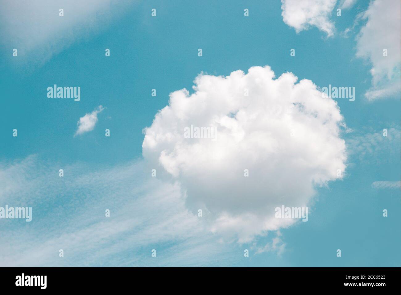 Beautiful round white cloud floats on a light sky Stock Photo - Alamy