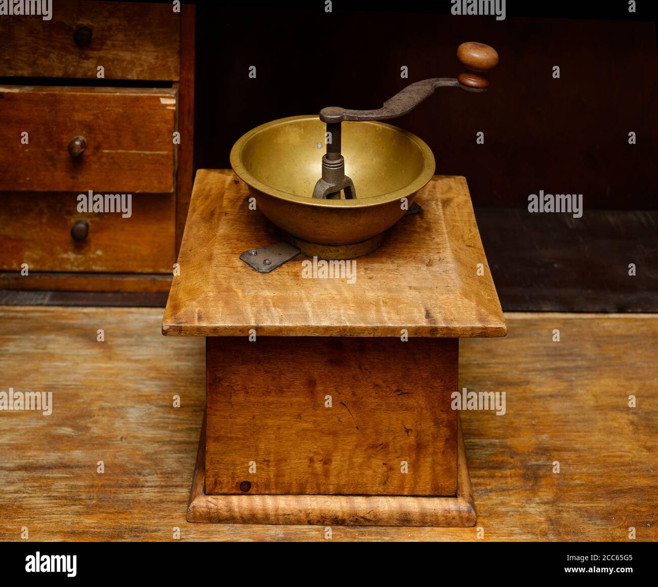 Antique aged manual wooden coffee grinder, kitchen interior, old drawer ...