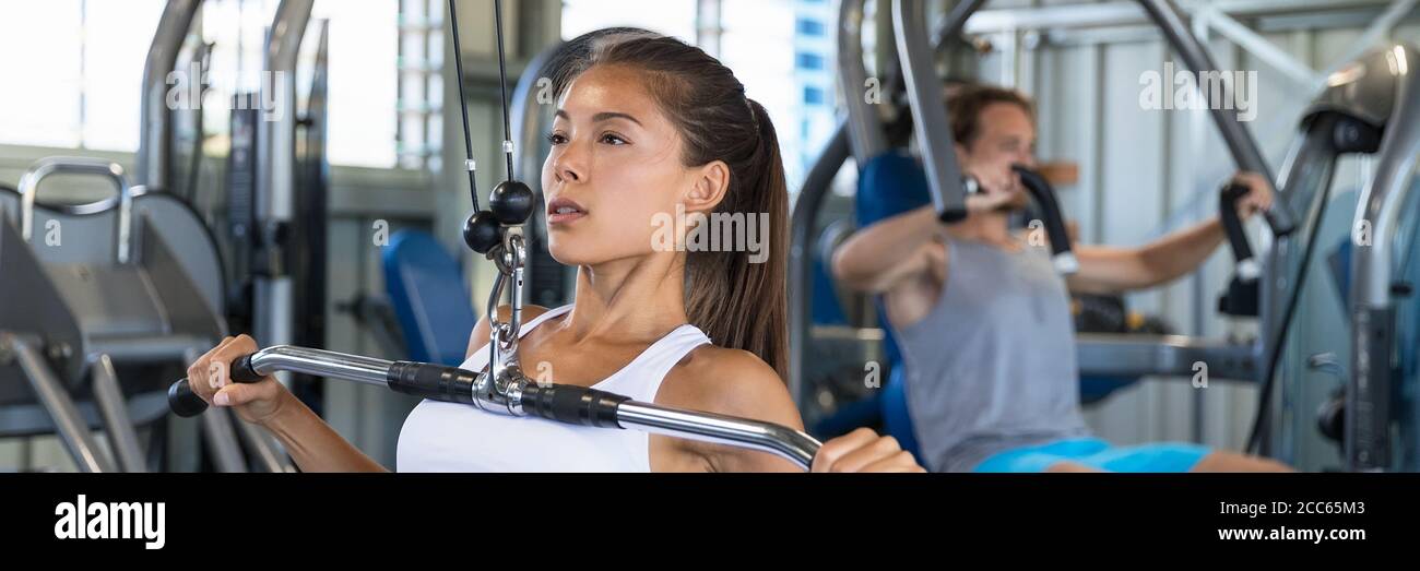 Gym woman working out using fitness machine banner Stock Photo - Alamy