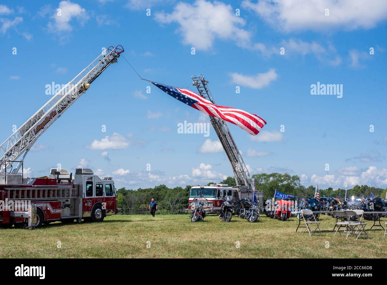 American flag displayed between two fire trucks at a political event ...