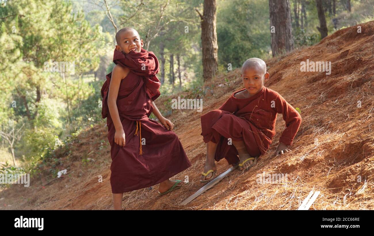 Young monks on a slope in the country side of Myanmar along the Kalaw ...