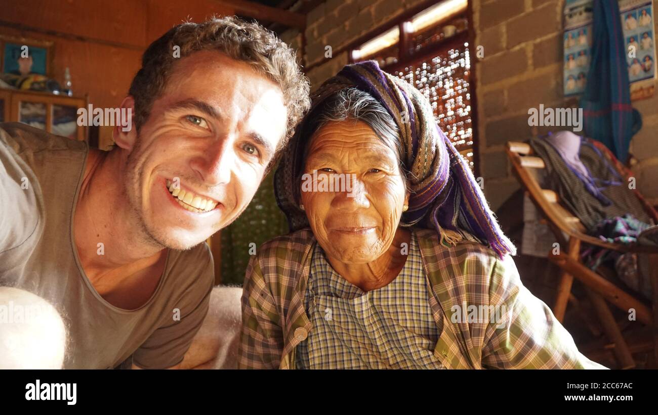 Elderly lady in a rural home on the country side of Myanmar along the ...