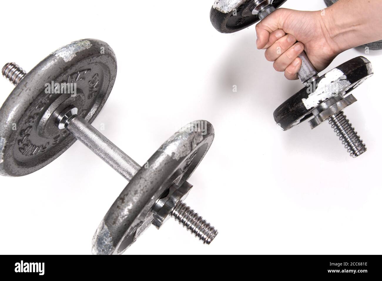 Dumbbell on a white background being grabbed Stock Photo - Alamy