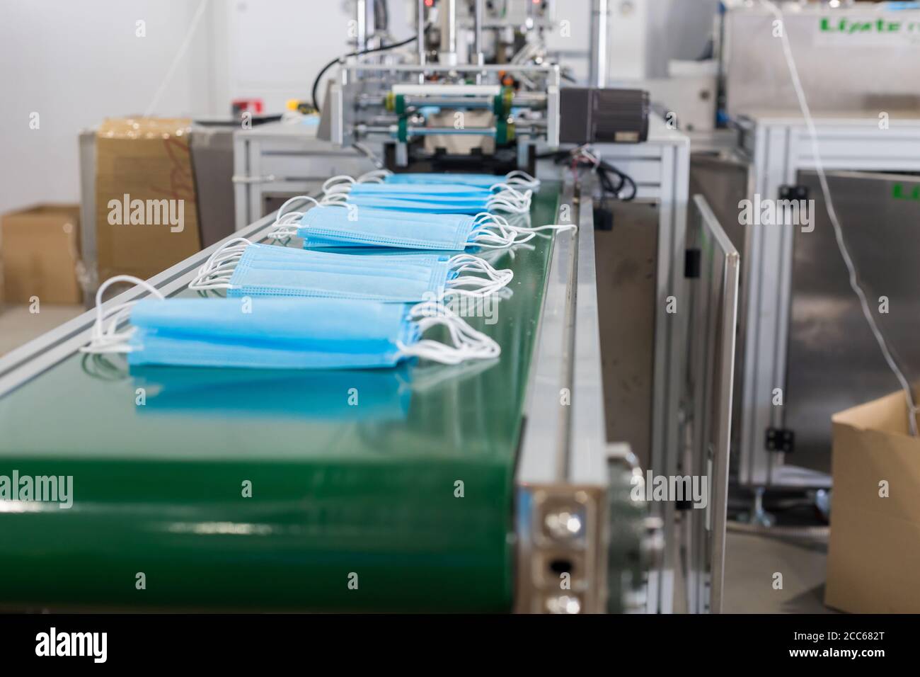 Production of medical masks - masks on the production bend. Mid shot ...