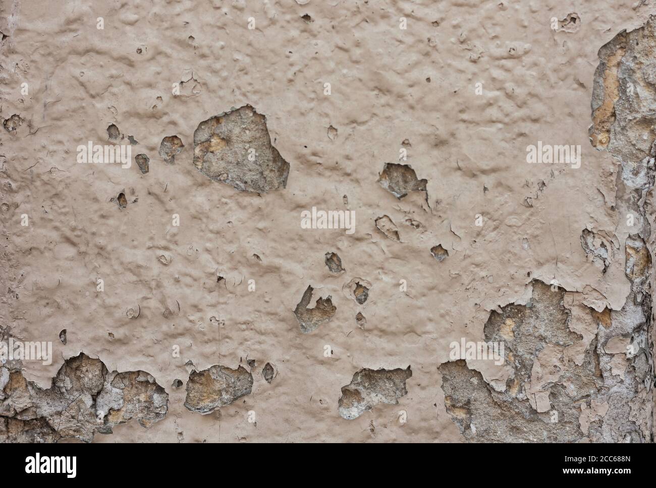 texture of a stone wall of an old building with crumbling plaster ...