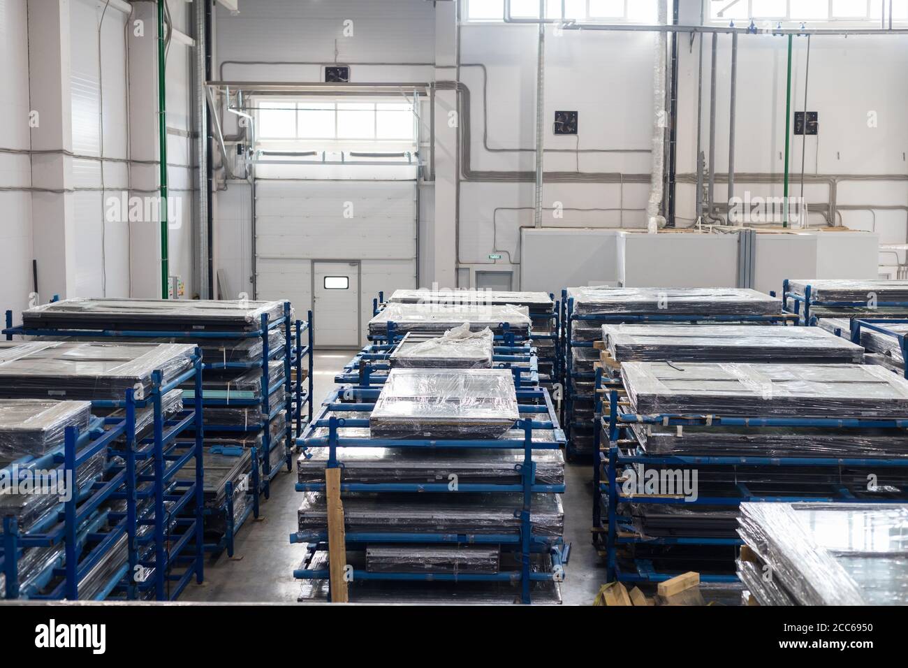 Modern warehouse filled with plastic windows packed in polyethylene ...