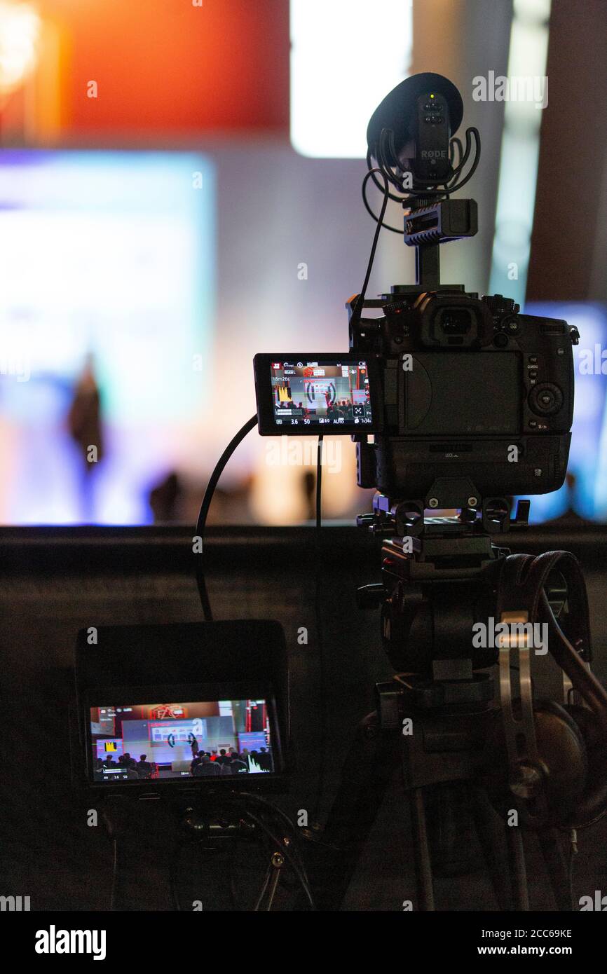 Camera filming indoors at conference Stock Photo - Alamy