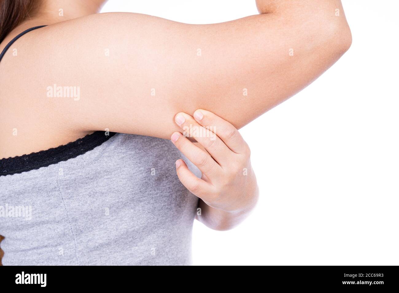 Woman holding excessive fat arm isolated on over white background ...
