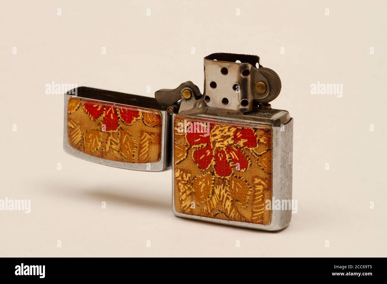 Open old lighter in red and beige cap. Lighter with a brand or logo can ...