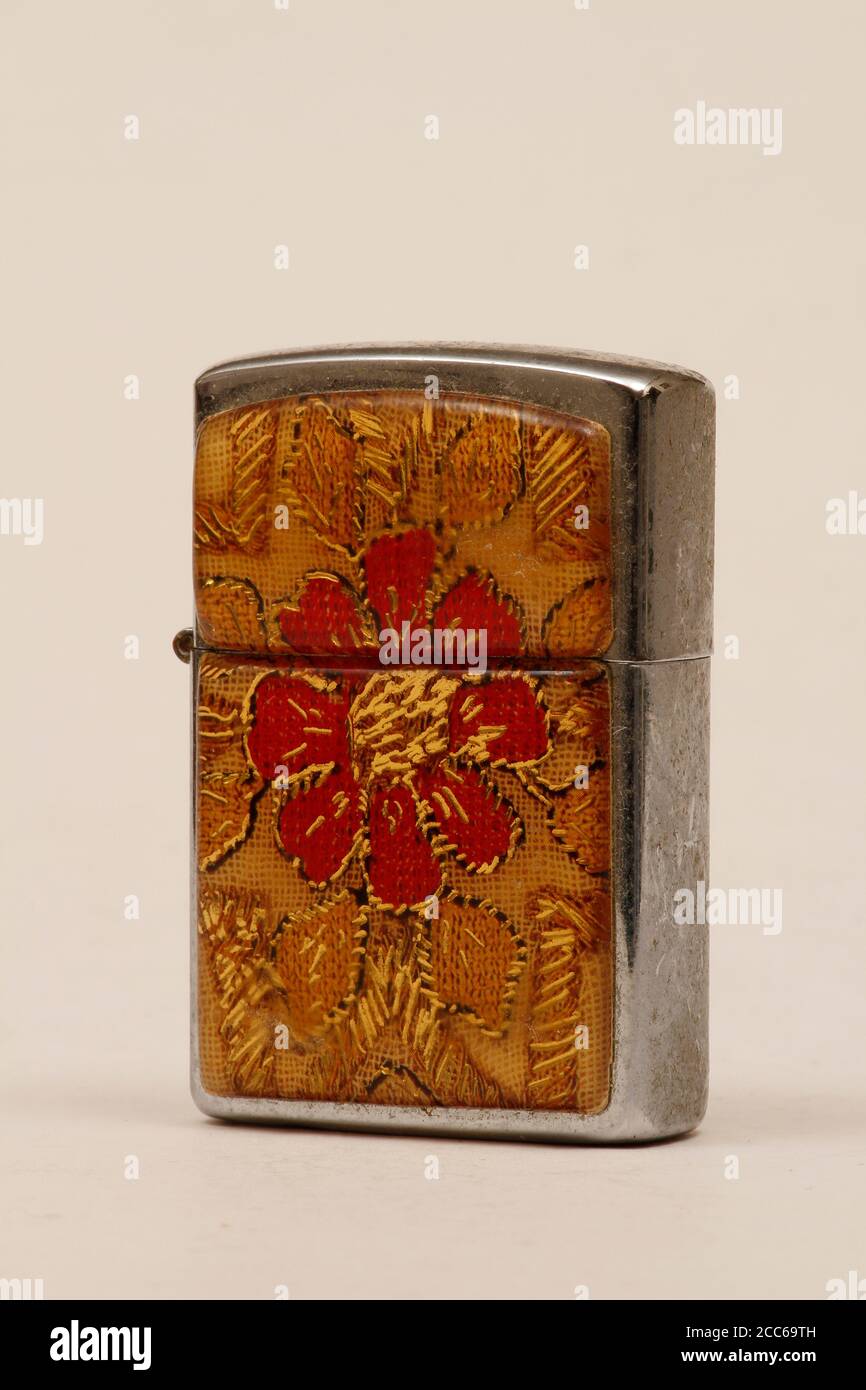 Open old lighter in red and beige cap. Lighter with a brand or logo can ...