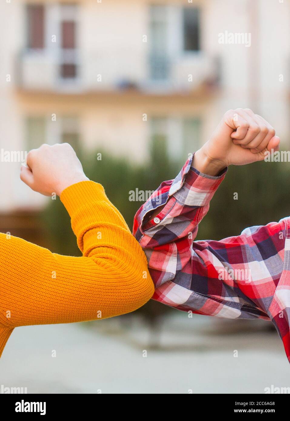 Two people bump elbows to avoid coronavirus outdoors. Coronavirus ...