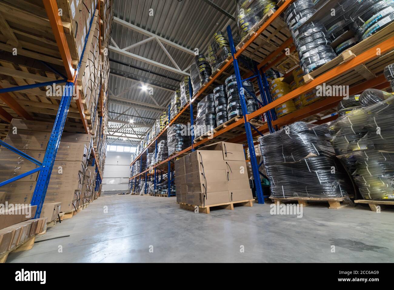Modern storehouse filled with wires lying on the stands. Mid shot Stock ...