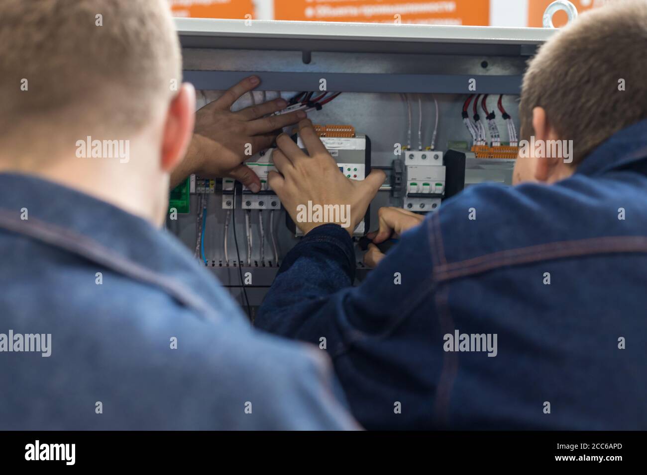 Industrial production of an electricity panel boards - two men workers ...