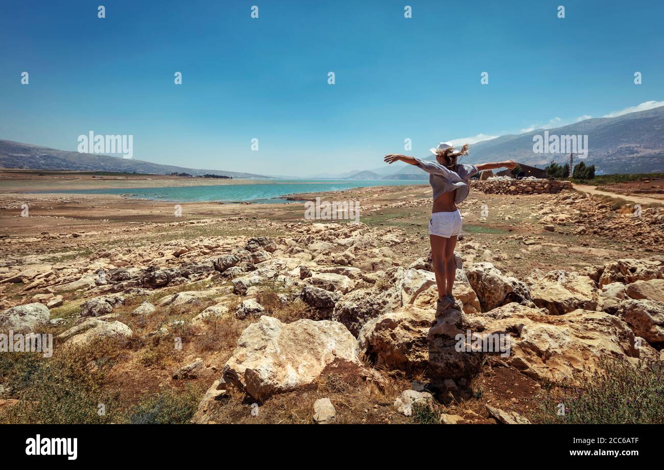 Happy Woman with Raised up Hands Standing Near Lakes and Enjoying ...