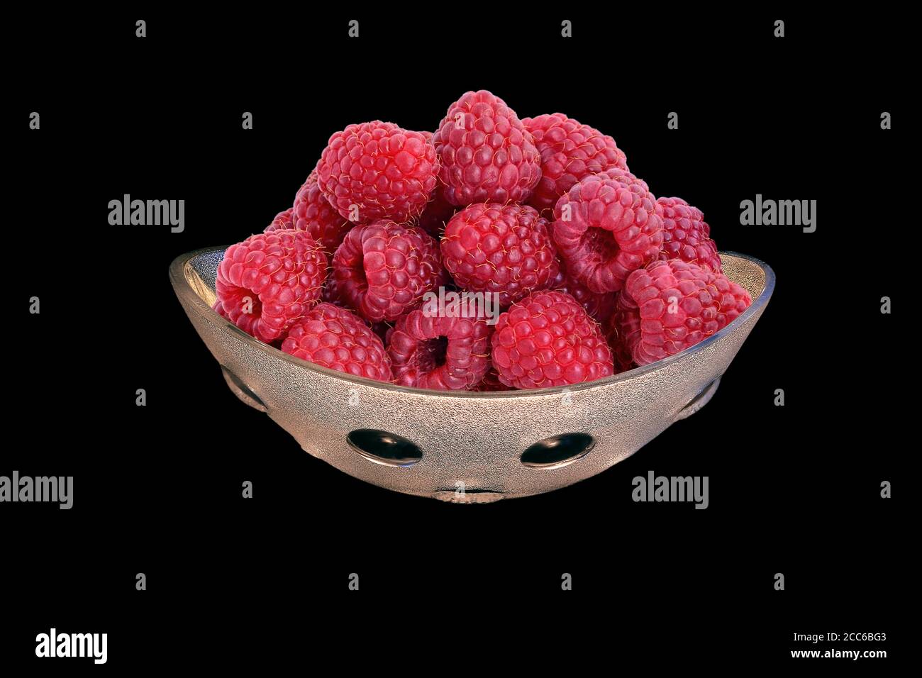 Tasty raspberries in a glass vase isolated on black background Stock ...