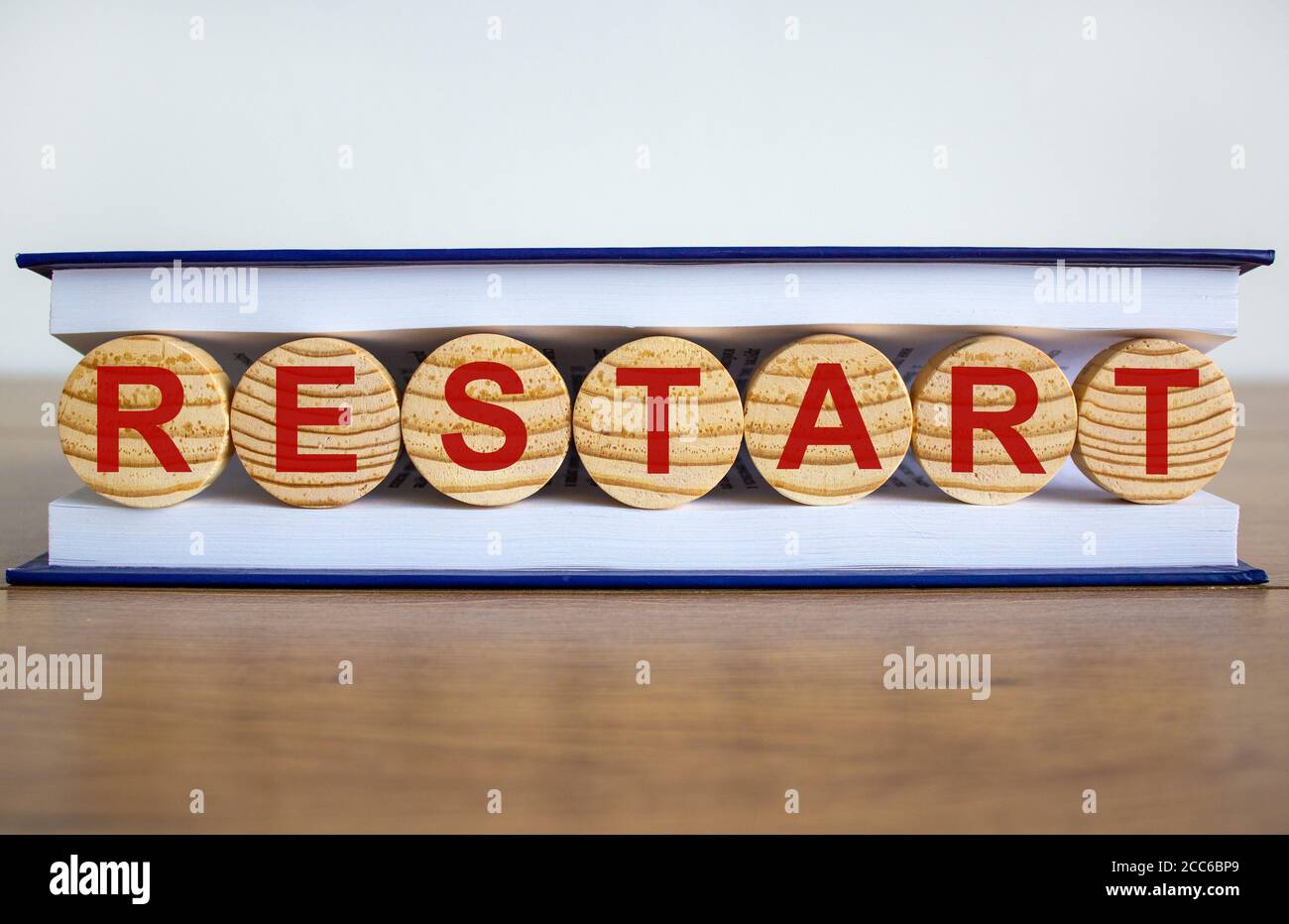 Concept word 'restart' on circles between pages of a book on a ...