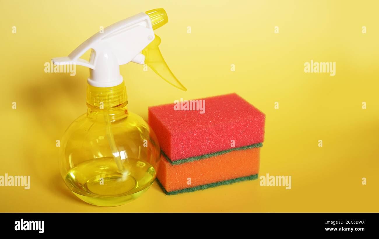 Cleaning products on a bright yellow background including spay cleaner ...