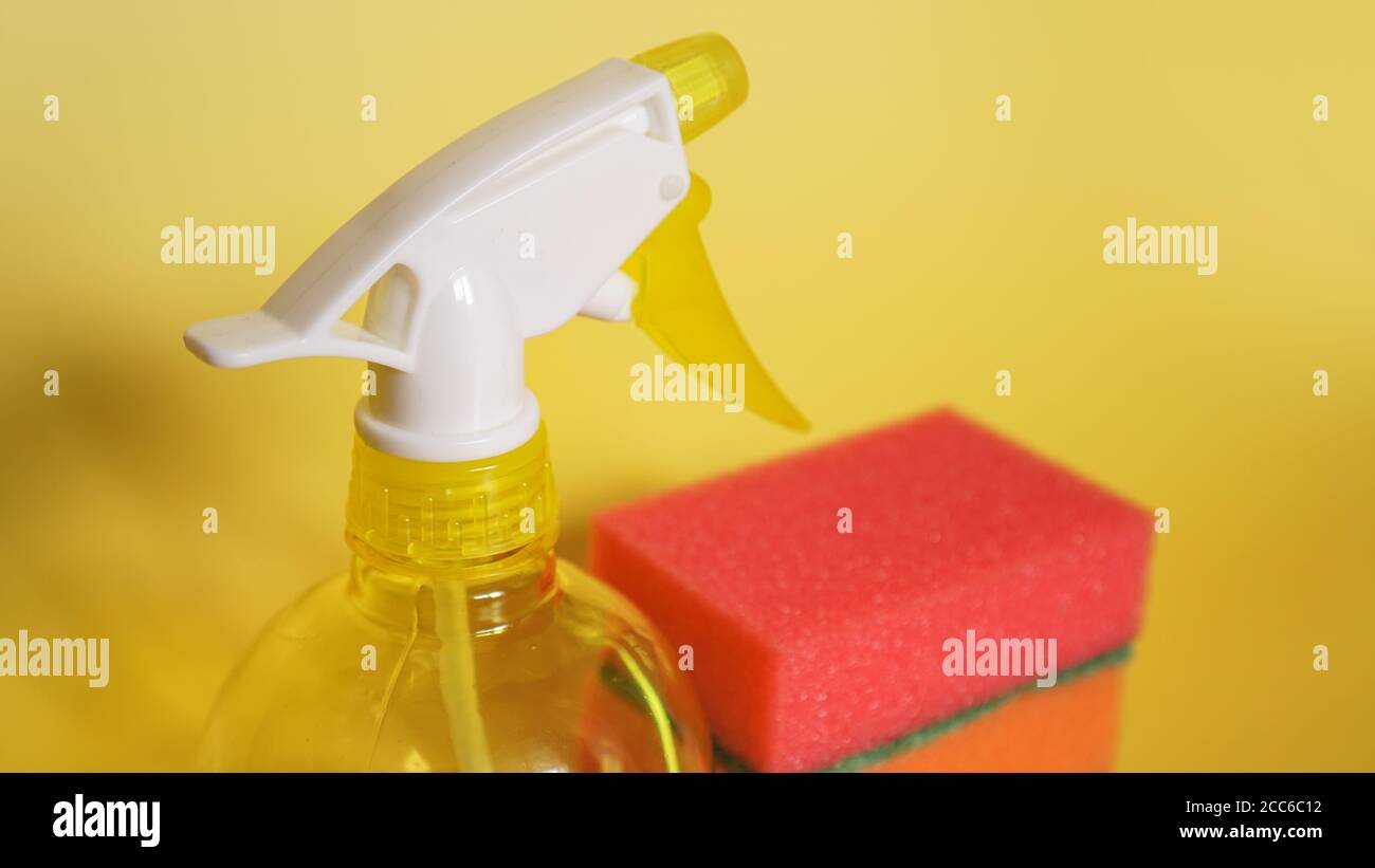 Cleaning products on a bright yellow background including spay cleaner ...