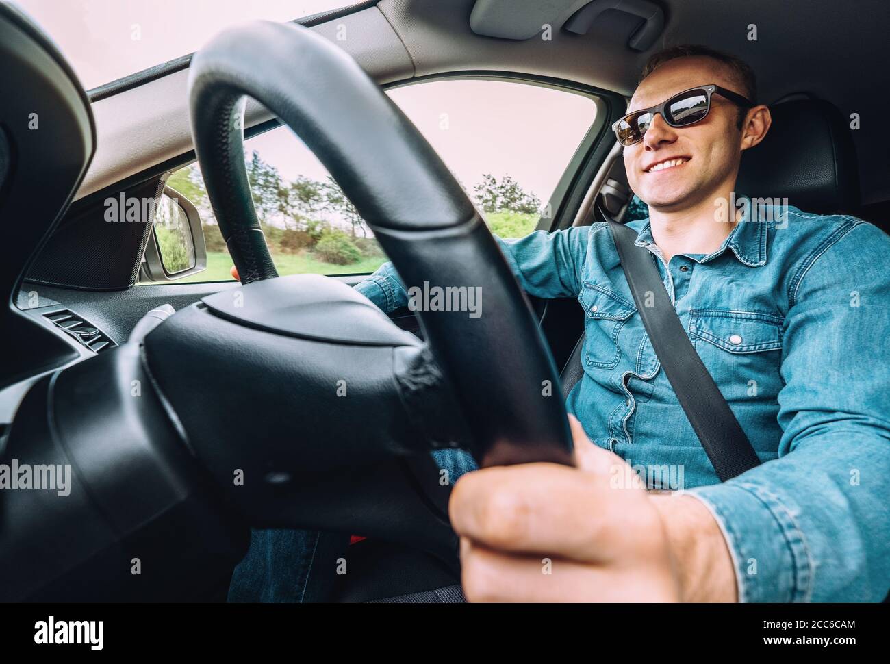 Man drives a car - inside wide angle view Stock Photo - Alamy