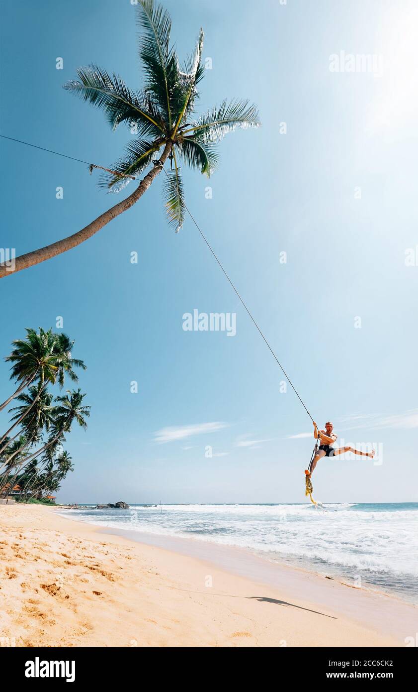 Palm tree swing hi-res stock photography and images - Alamy