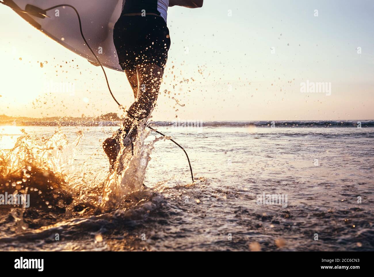 Closeup image water splashes from surfer's legs run in ocean with ...