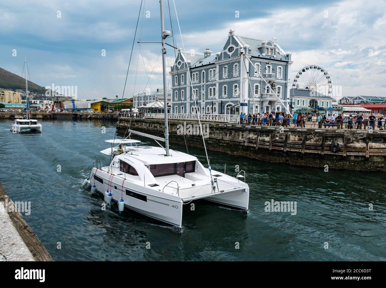 Luxury catamaran yachts passing Old Port Captain's Building, V&A ...