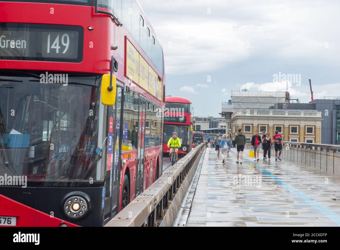 London, uk, 17-08-2020. london buses pass over London bridge with ...