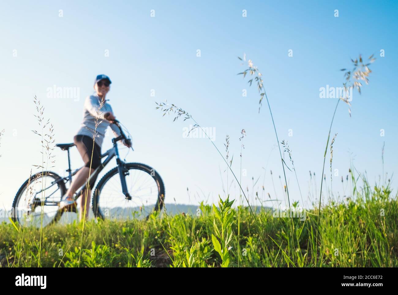 Summer activity: woman ride a bicycle Stock Photo - Alamy